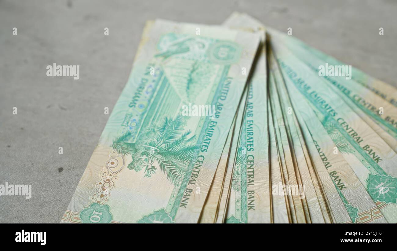 United arab emirates banknotes spread on a concrete surface ...