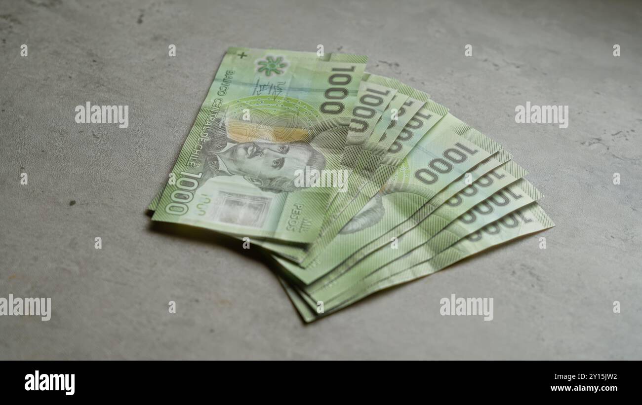 Chilean banknotes in 1000 pesos denominations arranged on a concrete ...