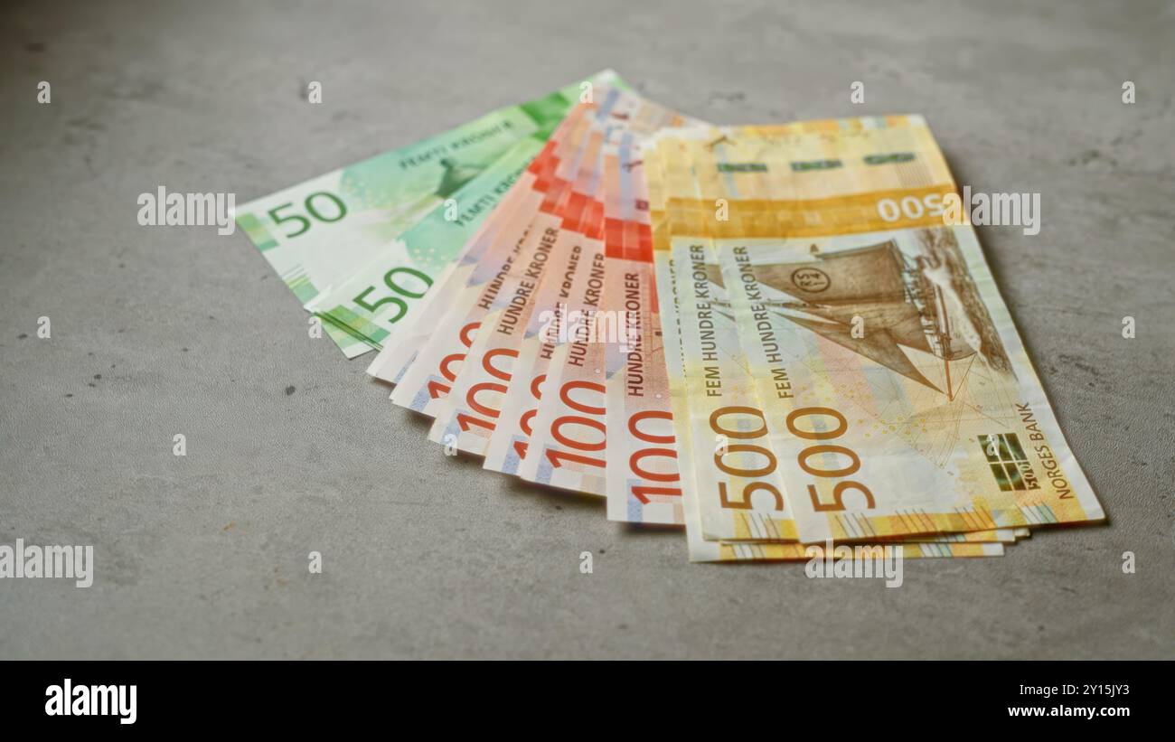 Norwegian banknotes of various denominations displayed on a concrete ...