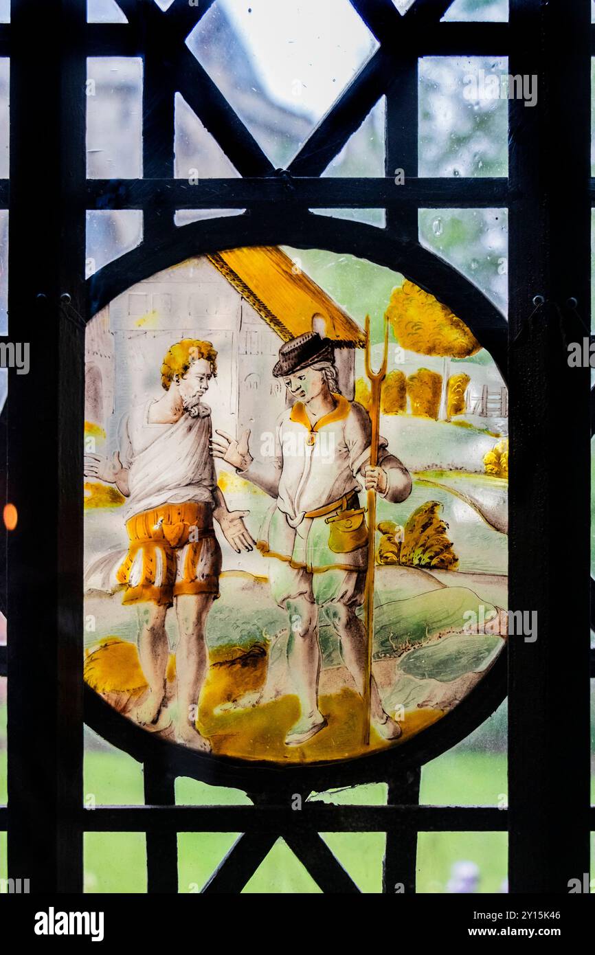 Colorful stained glass window depicting two historical figures in ...