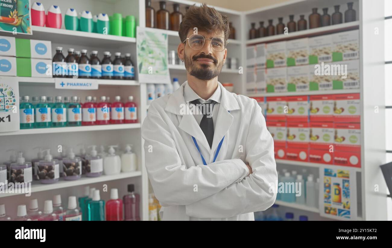 Confident young hispanic male pharmacist with arms crossed in a well ...