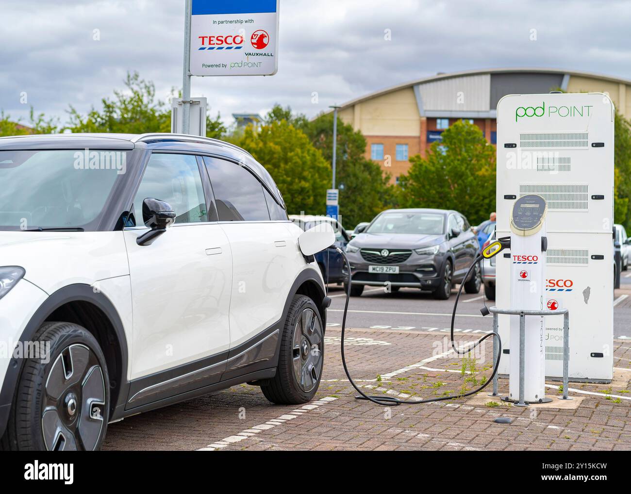 Podpoint electric car charging point in use at a Tesco shopping store ...