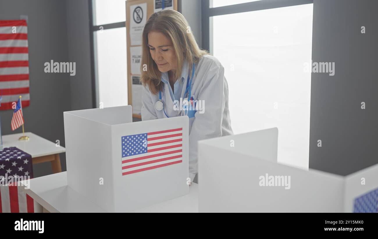 A middle-aged woman in a lab coat votes inside an american voting booth ...