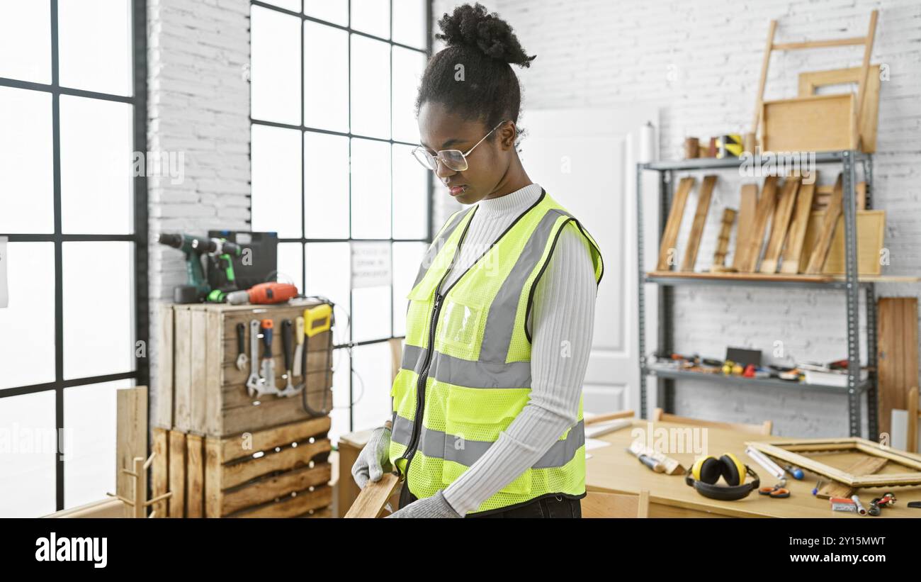 African american woman carpenter working in a well-equipped indoor ...