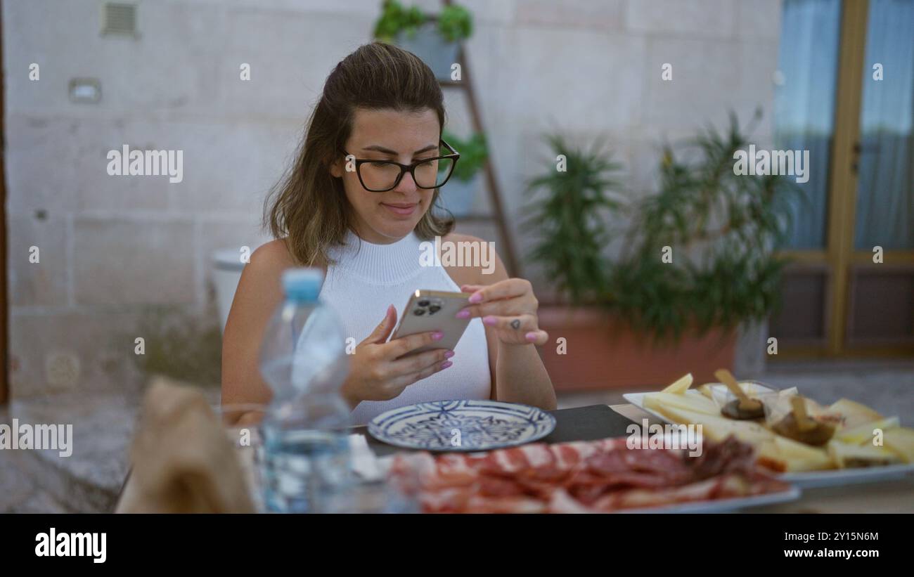 A young beautiful hispanic woman at a restaurant terrace in italy ...