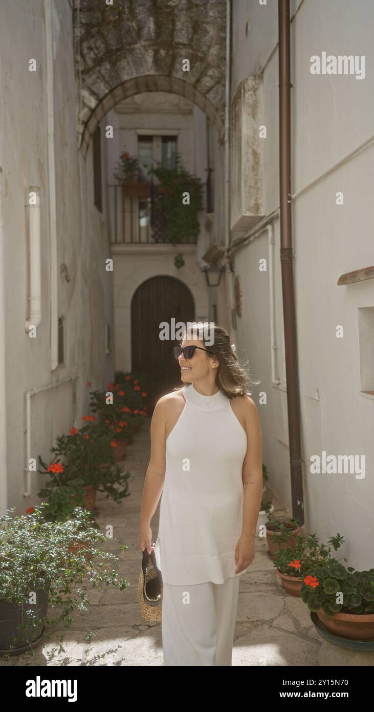A young hispanic woman strolls through the beautiful streets of the old ...