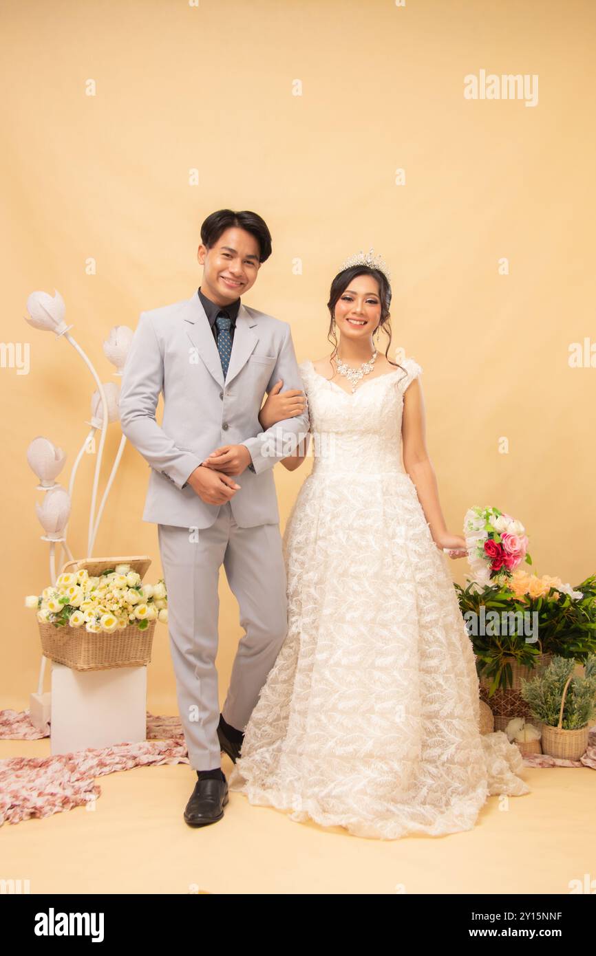male and female couple walking poses smiling at each other in front of ...
