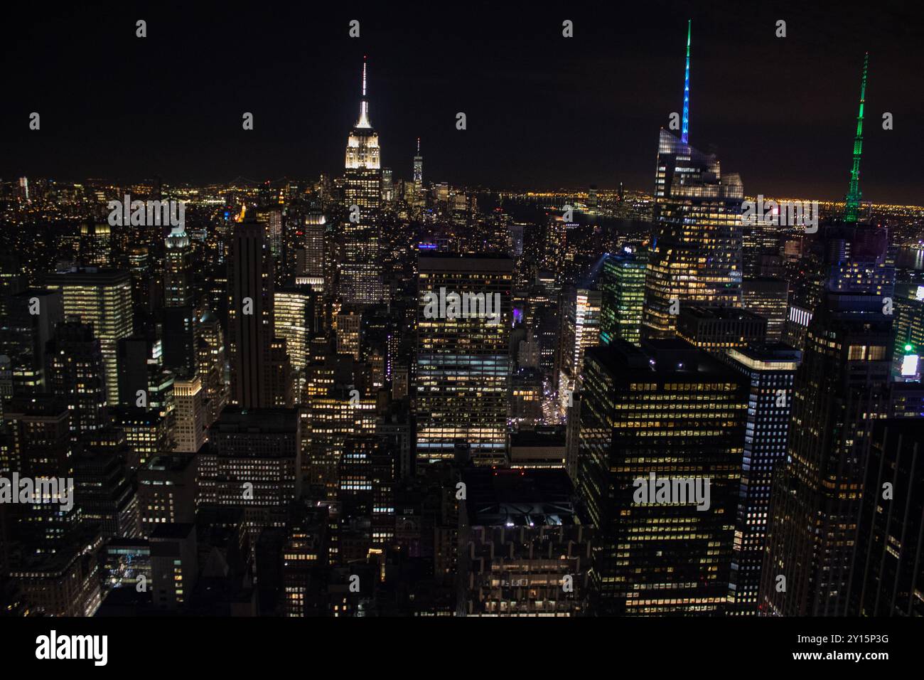 Night time aerial view of Manhattan in New York City showing the ...