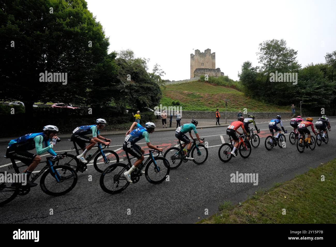 The peloton go past Conisbrough Castle in Doncaster during stage three ...