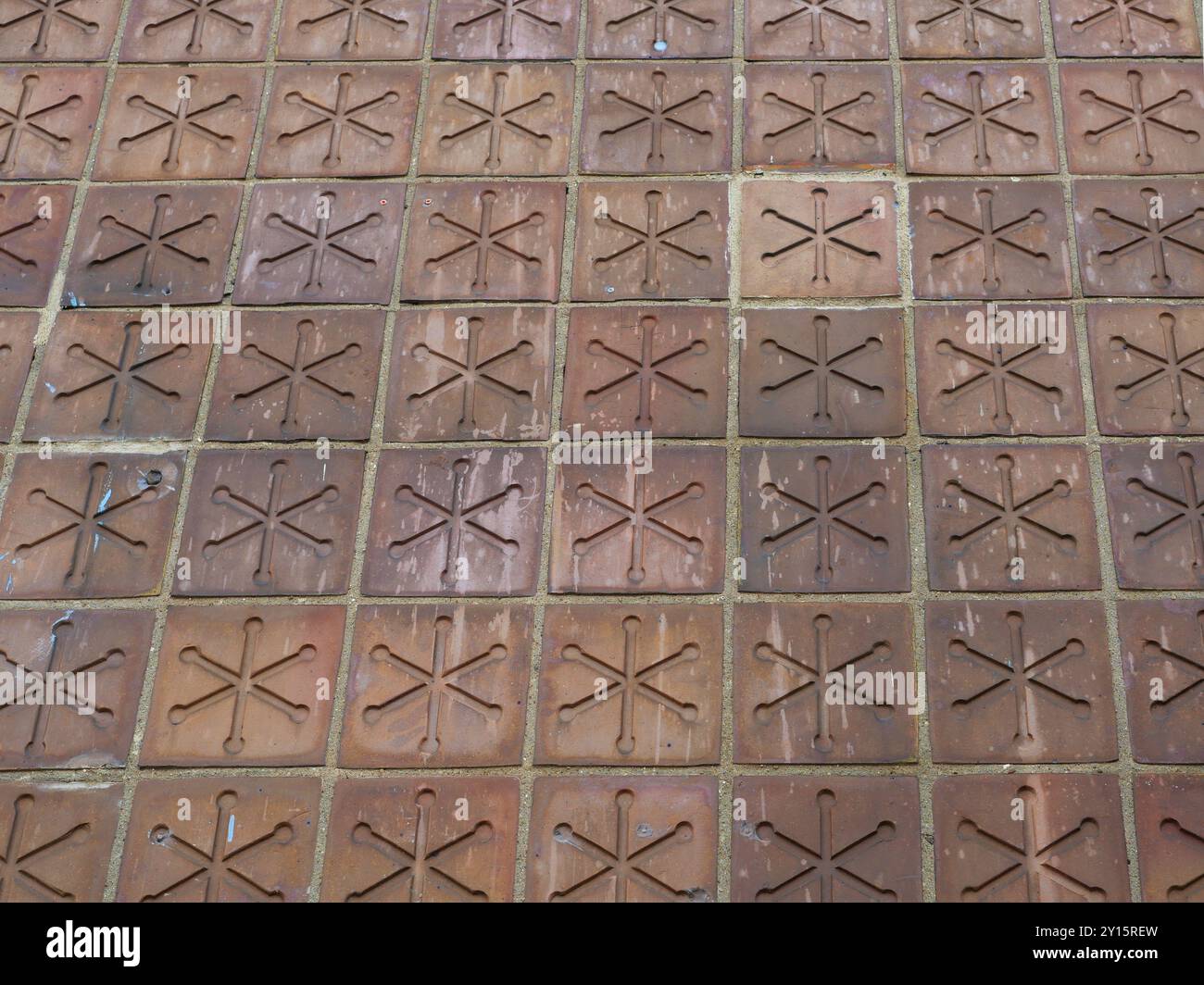Square reddish clinker paving with a diagonal cross pattern creates a ...