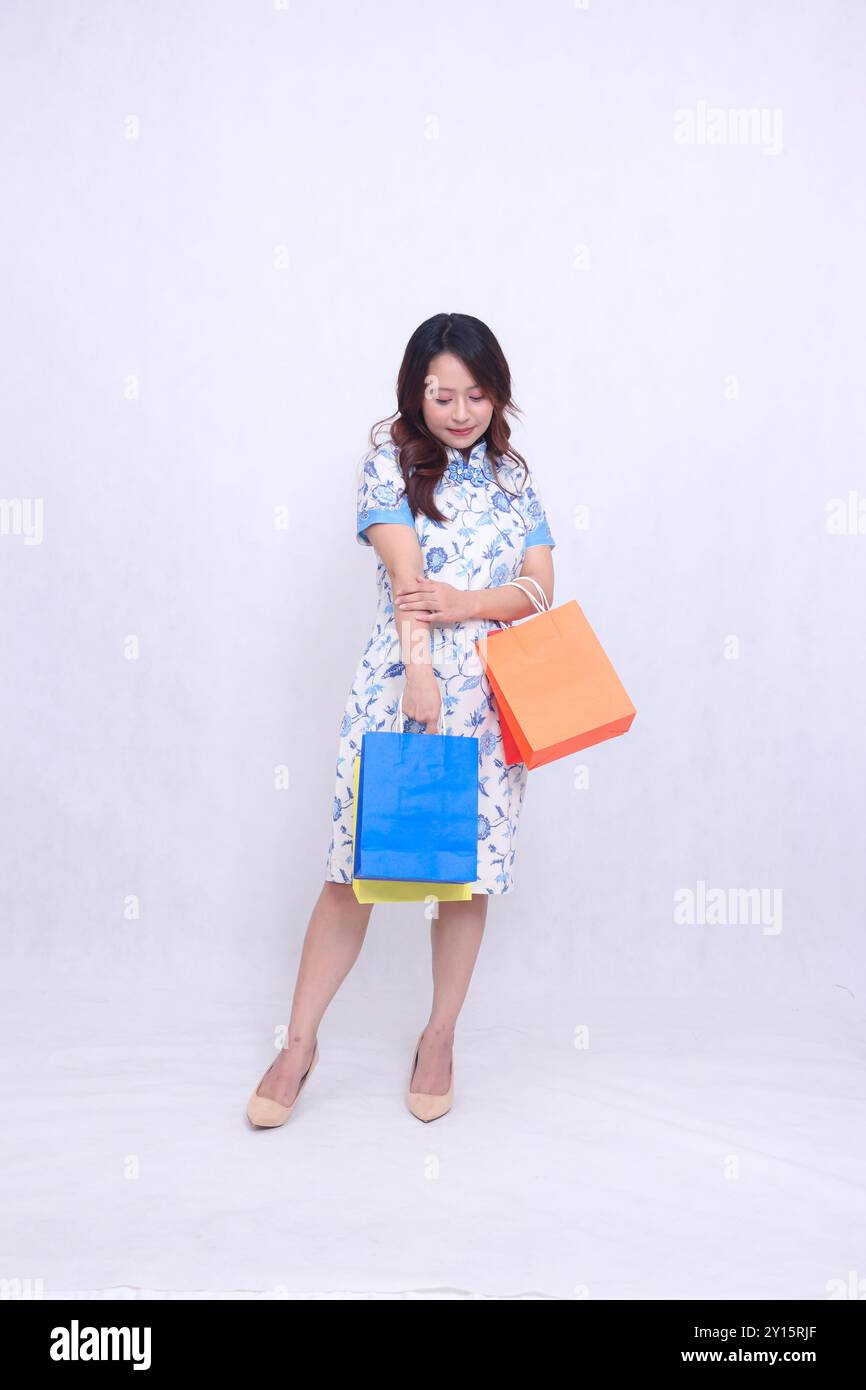 full body Young Indonesian woman smiling candidly wearing a modern ...