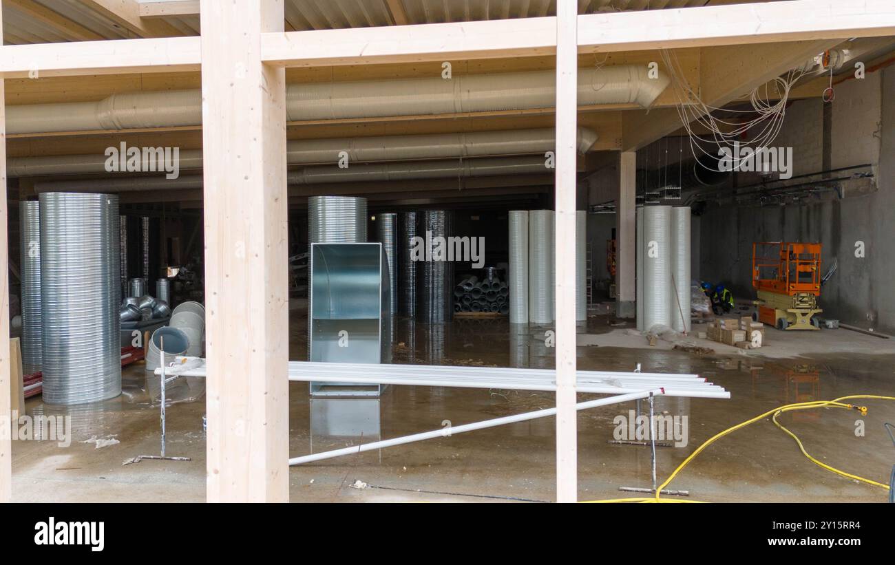 Construction site featuring a wooden structure with large windows ...