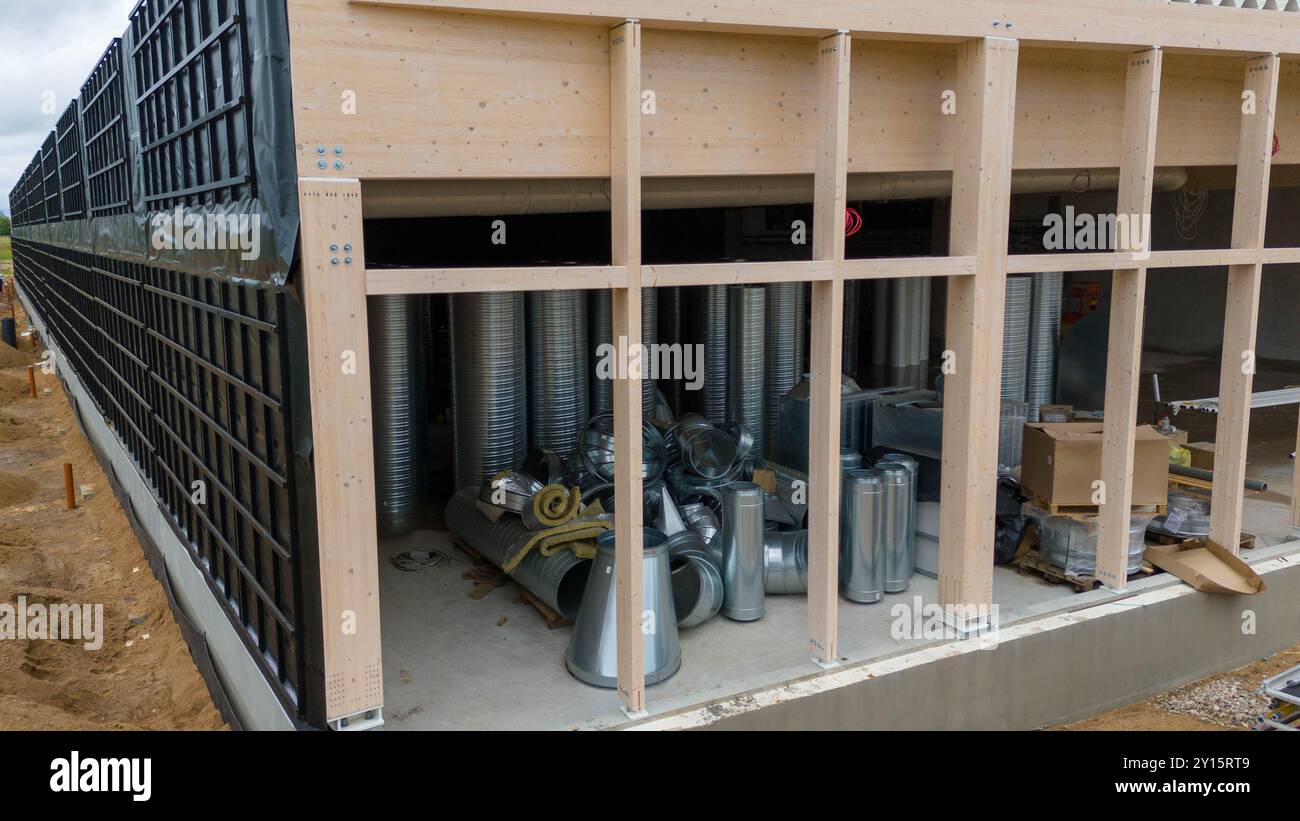 Construction site featuring a wooden structure with large windows ...