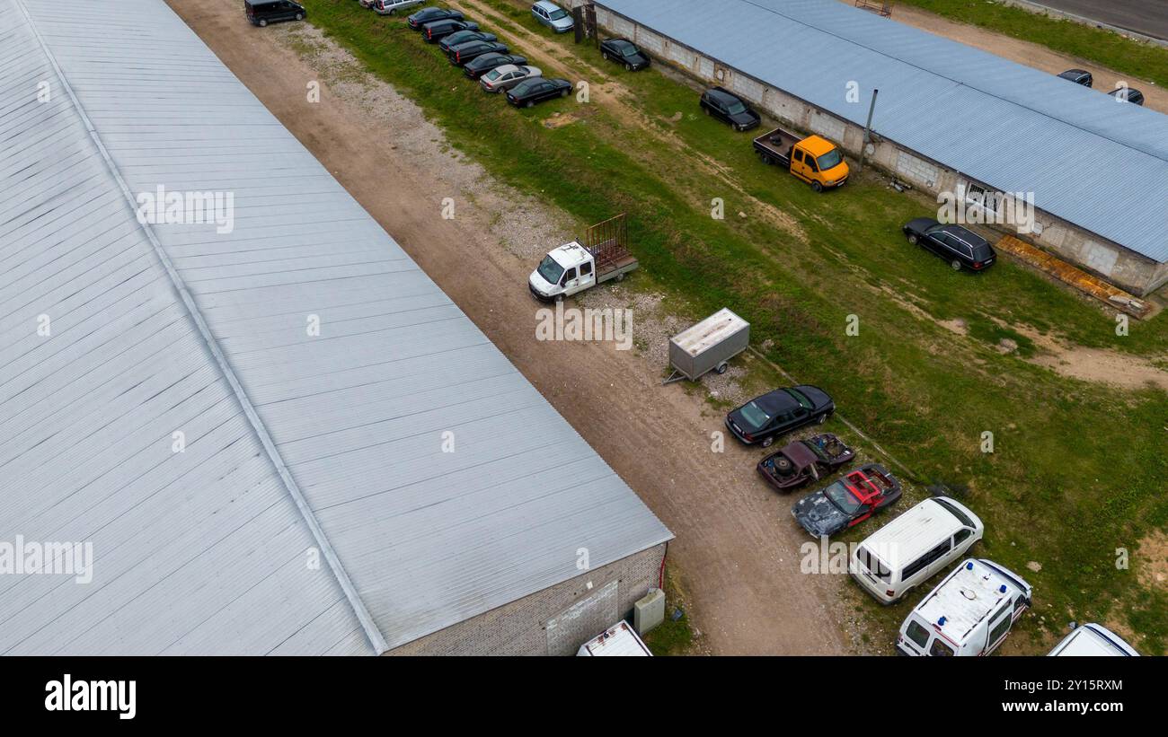 An aerial view of a commercial area featuring several buildings, parked ...