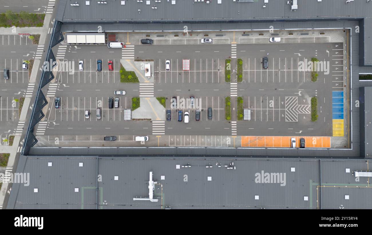 Aerial view of a large parking lot with various parked cars. The lot ...