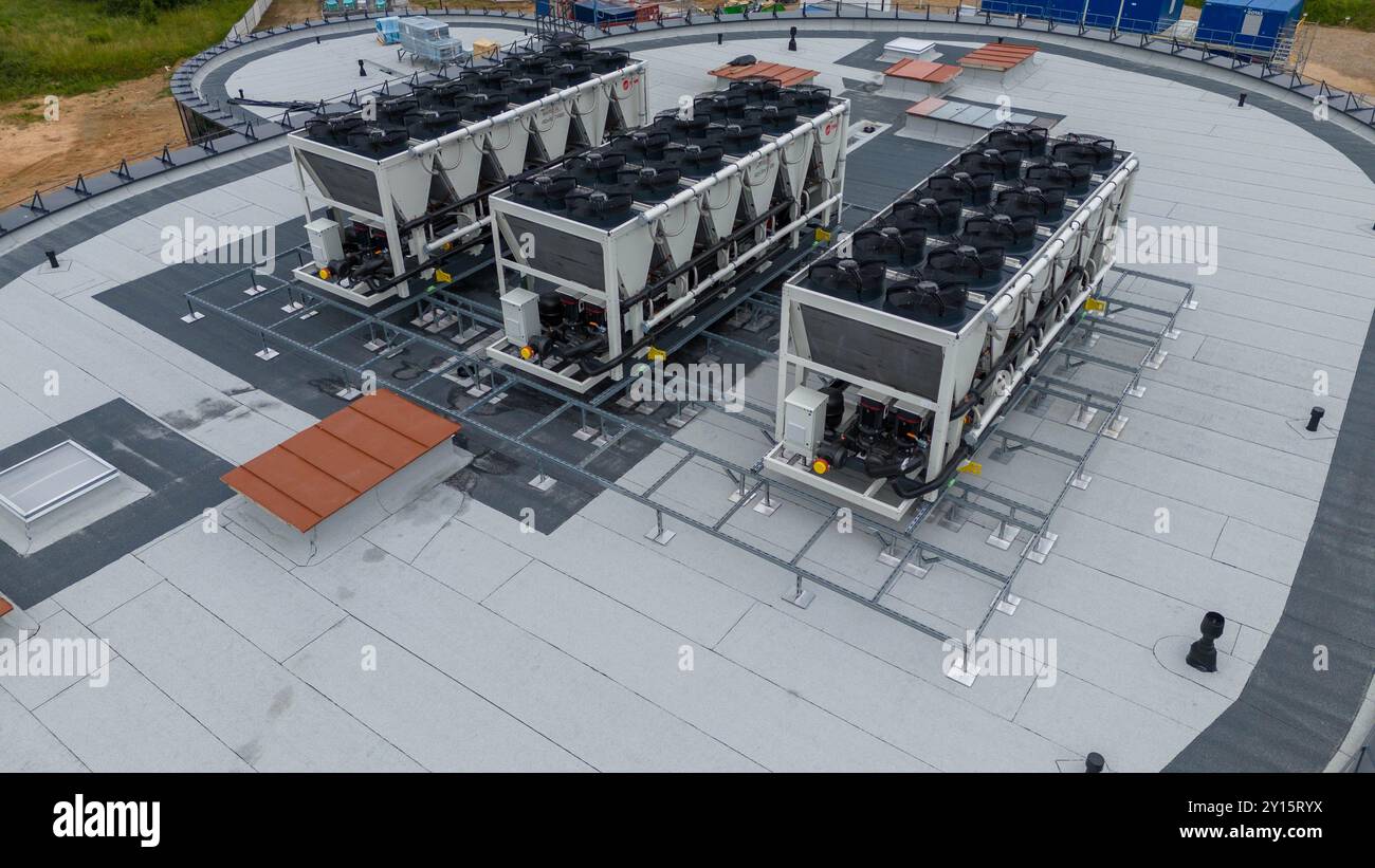 Aerial view of a commercial building rooftop featuring various HVAC ...