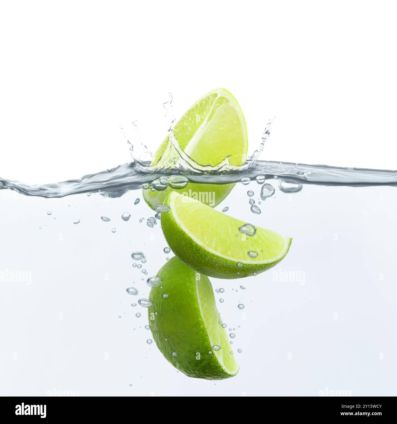 Sliced lime falling into water against white background Stock Photo - Alamy