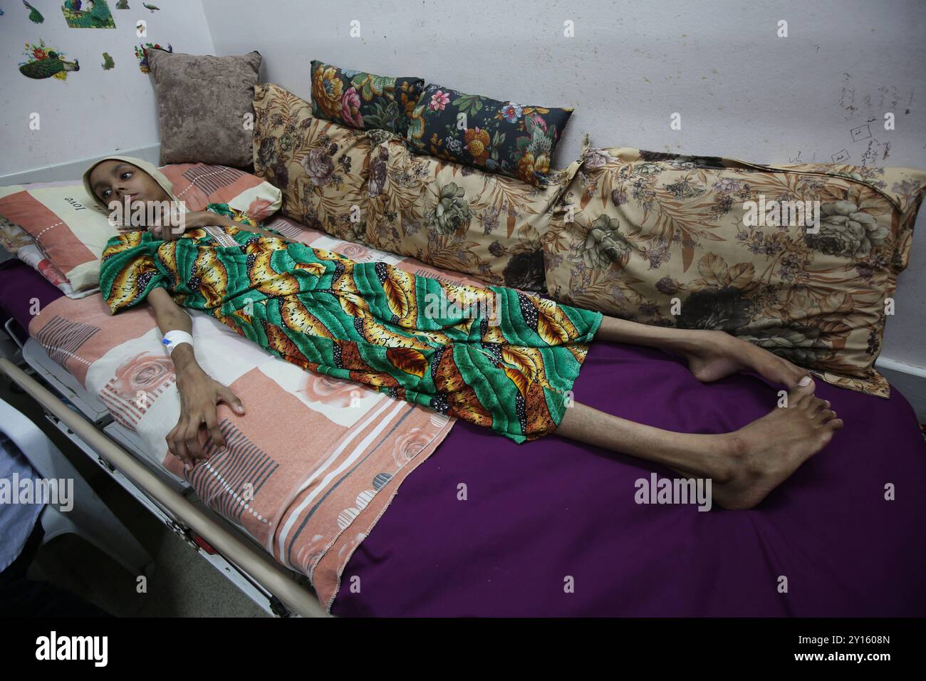 Palestinian girl Bashayer Al-Abeed 17 years old lies on the bed ...