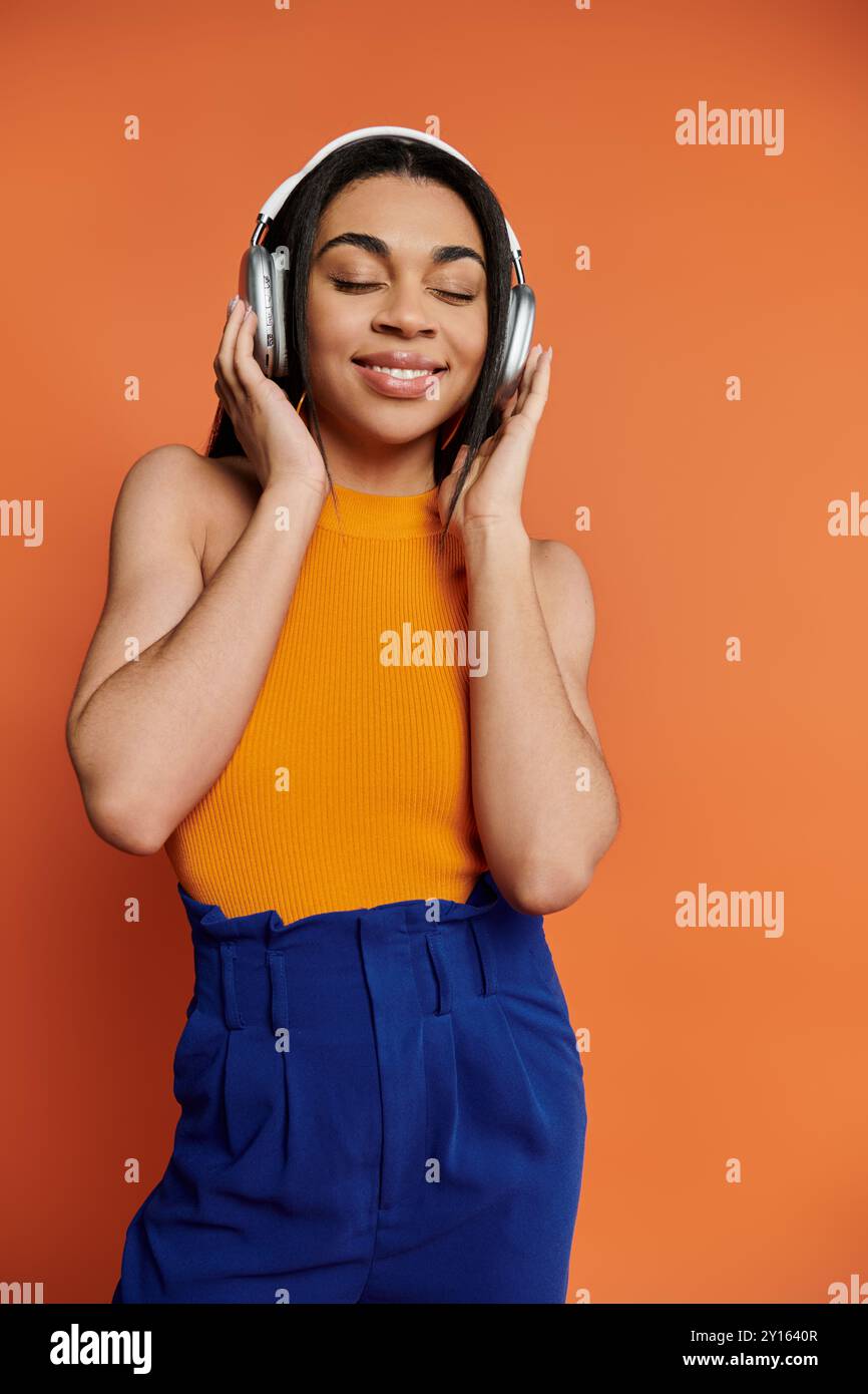 A woman listens to music with a cheerful smile, immersed in rhythm and ...