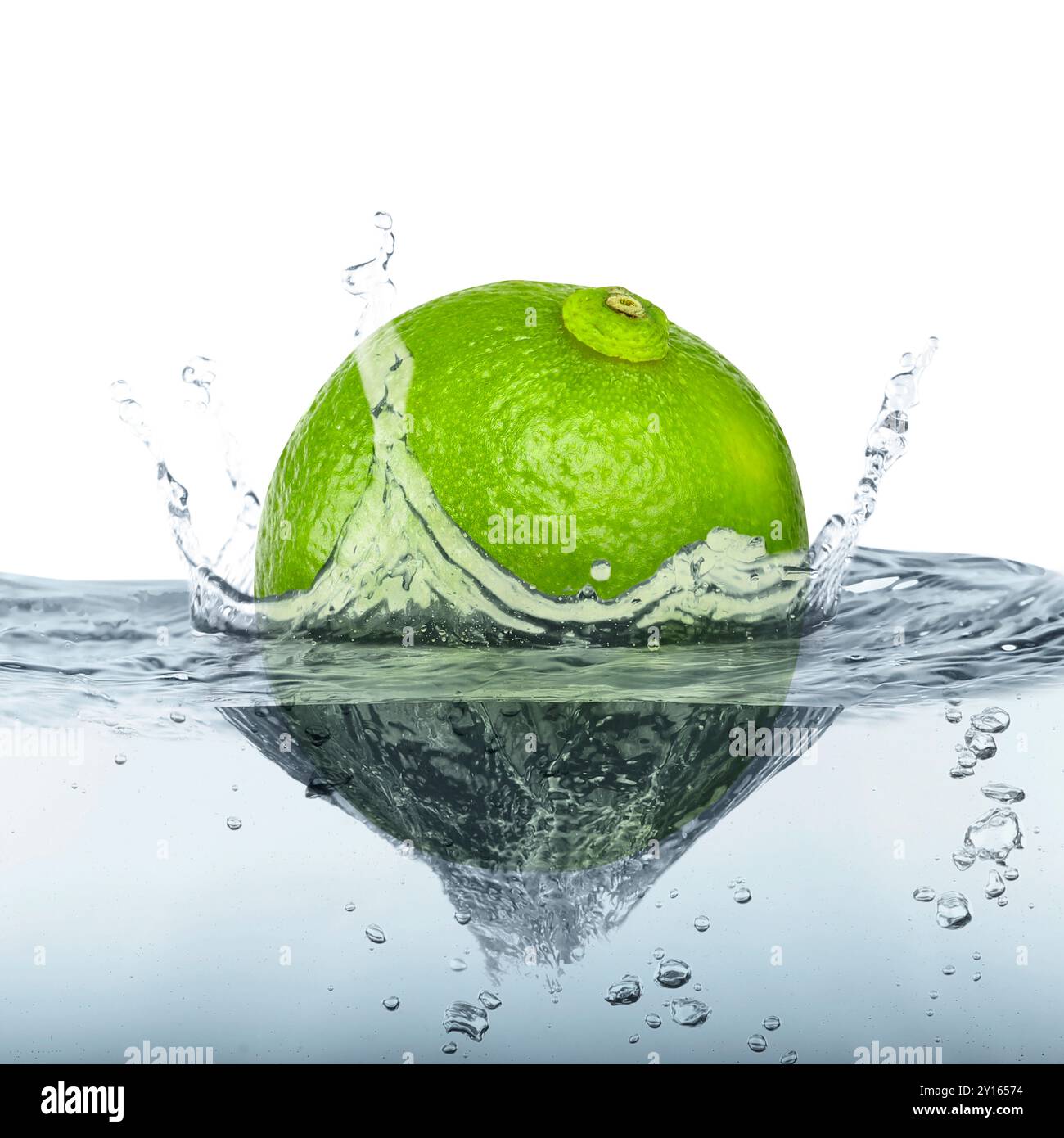 Fresh lime falling into water against white background Stock Photo - Alamy