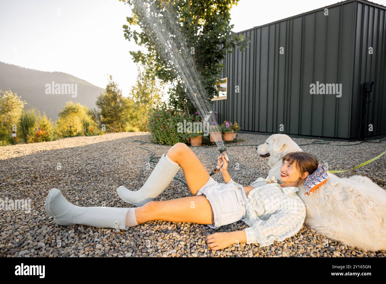 A peaceful moment as a woman relaxes with her loyal dog in a sunny ...