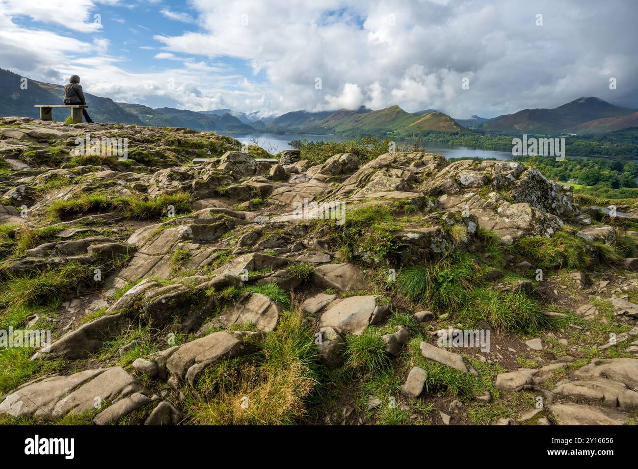 A woman seated on the bench at the rocky viewpoint at Castlehead across ...