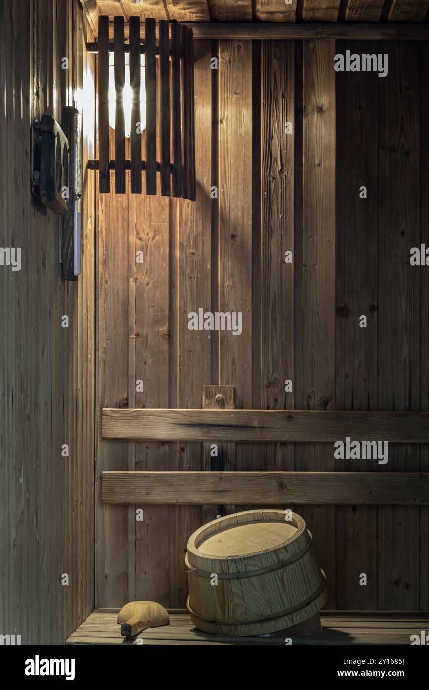 The space is warmly lit by a wall-mounted lamp, casting a cozy glow ...