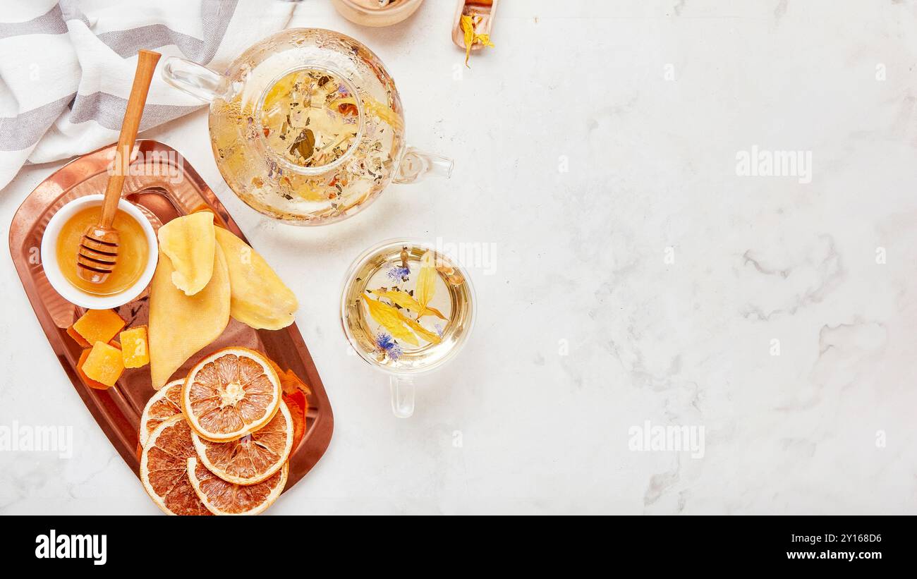 Aesthetic tea time, herbal tea table setting with natural honey and dry ...