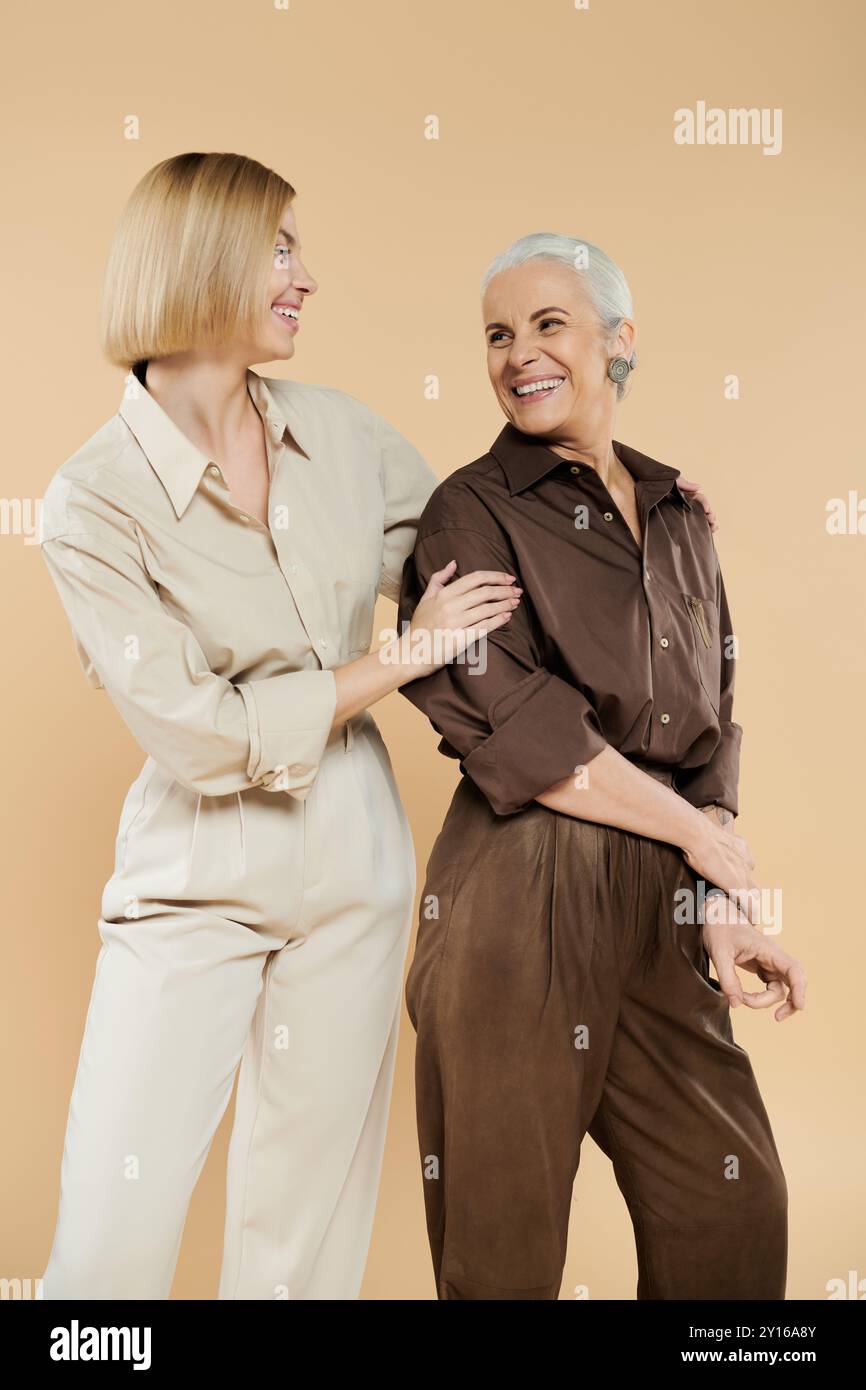Two women share a warm smile and laughter, showcasing their strong ...