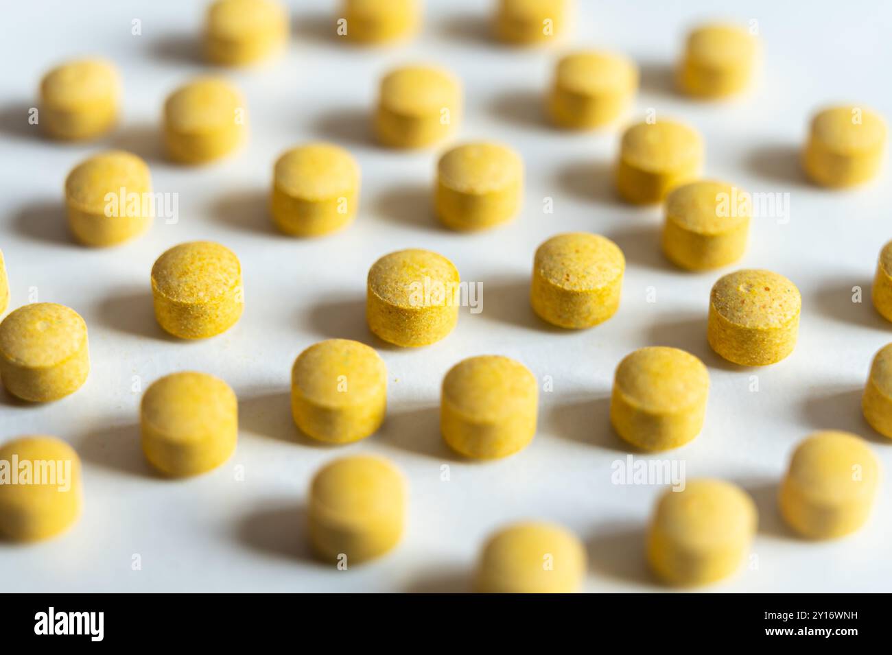 Medical tablets, placed next to each other on a white surface ...