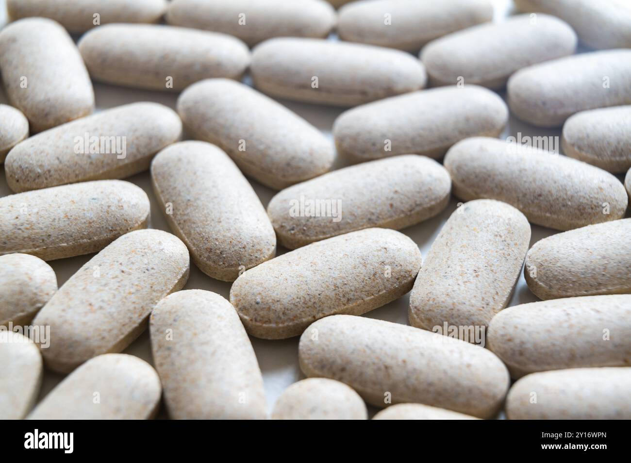 Medical tablets, placed next to each other on a white surface ...