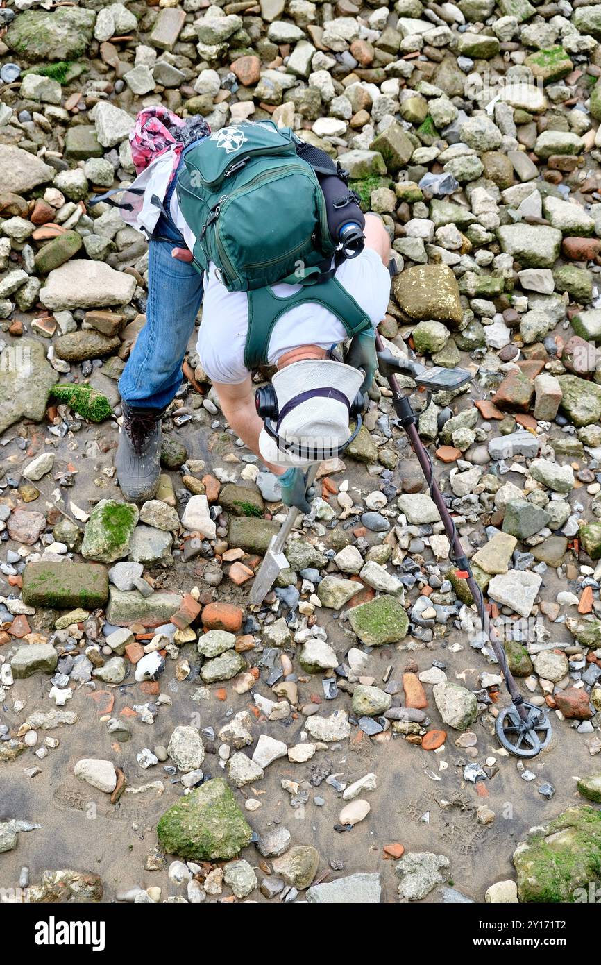 Searching for objects with a metal detector at low tide on the ...
