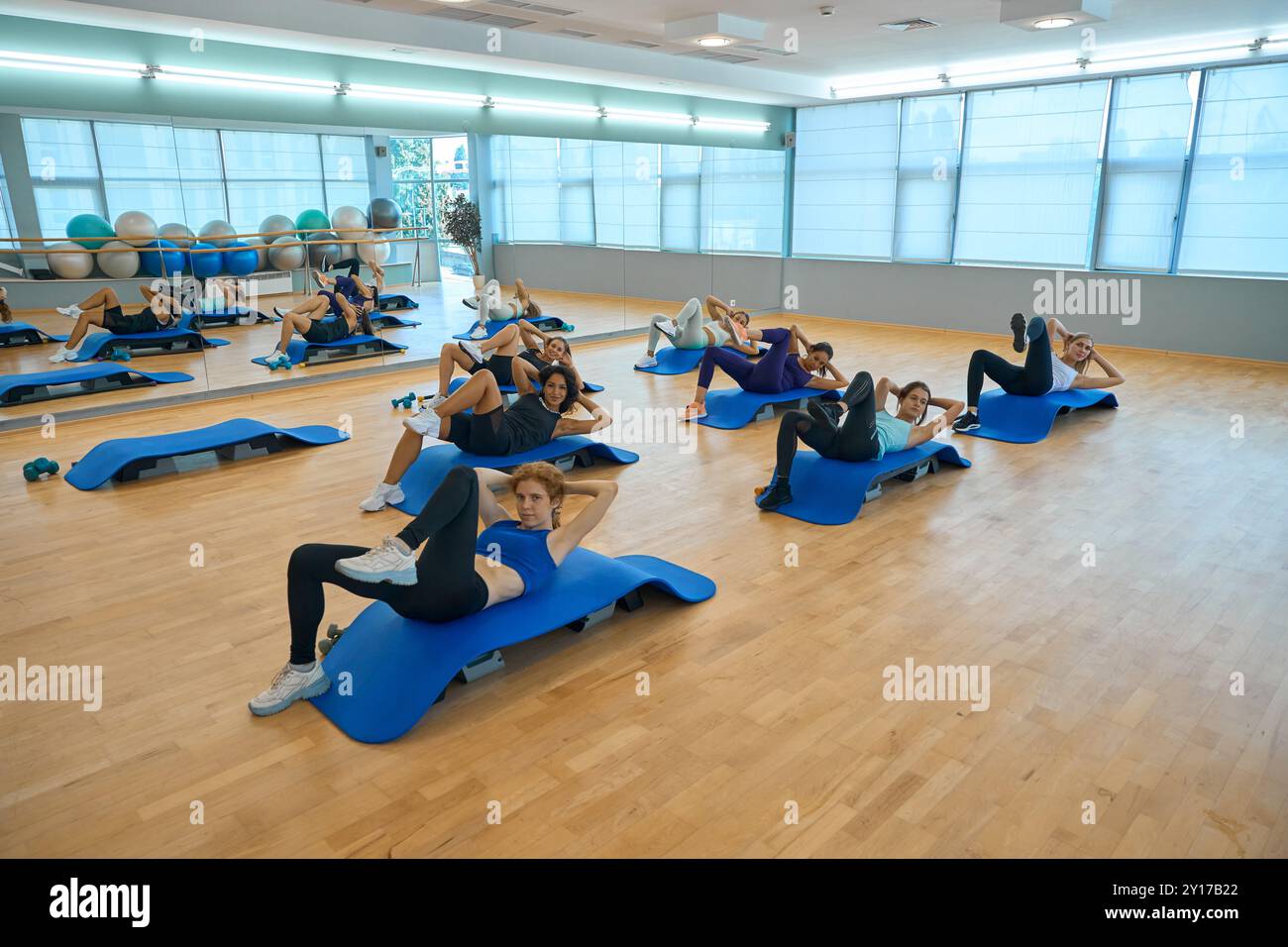 Women perform exercises to strengthen their abdominal muscles Stock ...