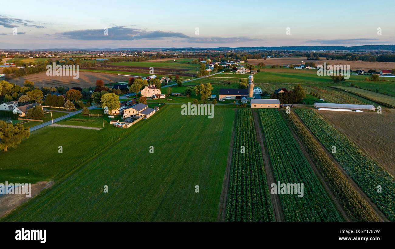 The view captures a peaceful rural community with expansive fields ...