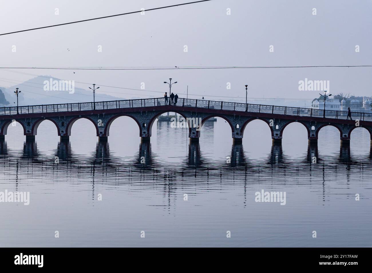 Serene Morning at Udaipur's Historic Arched Bridge Over Tranquil lake ...