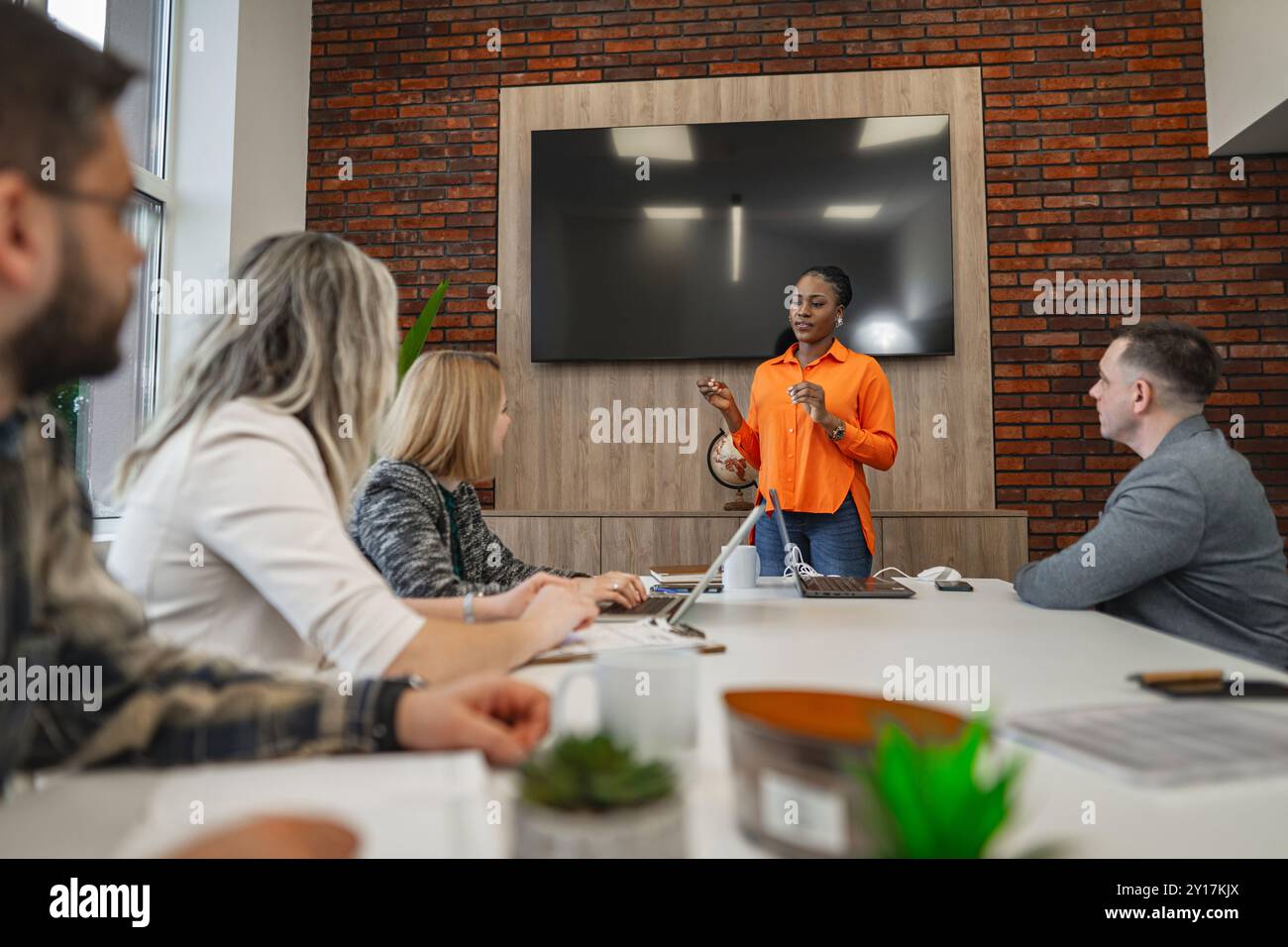 Professionals sitting around conference table hi-res stock photography ...