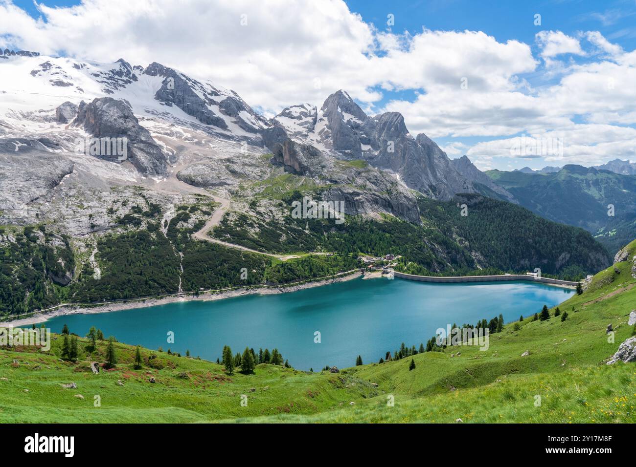 Fedaia lake and dam, Marmolada massif group background with glacier ...