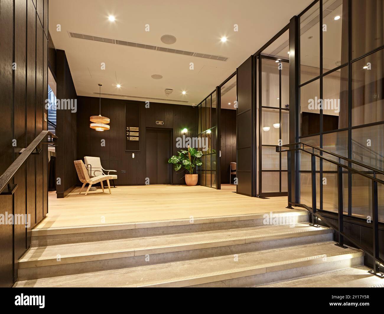 Entrance with lift lobby. Woolyard, London, United Kingdom. Architect ...