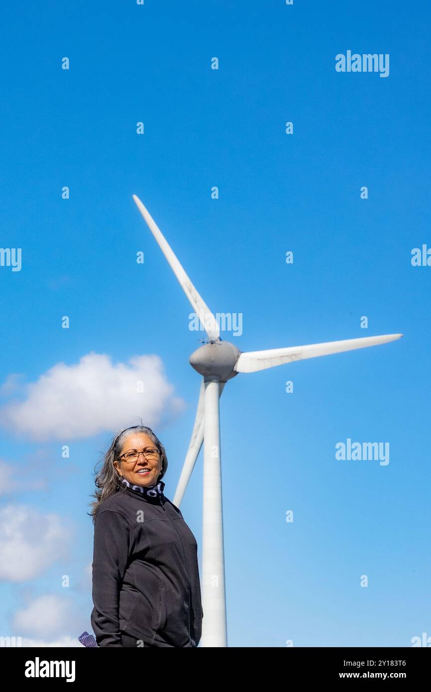 Smiling engineer standing against wind hi-res stock photography and ...