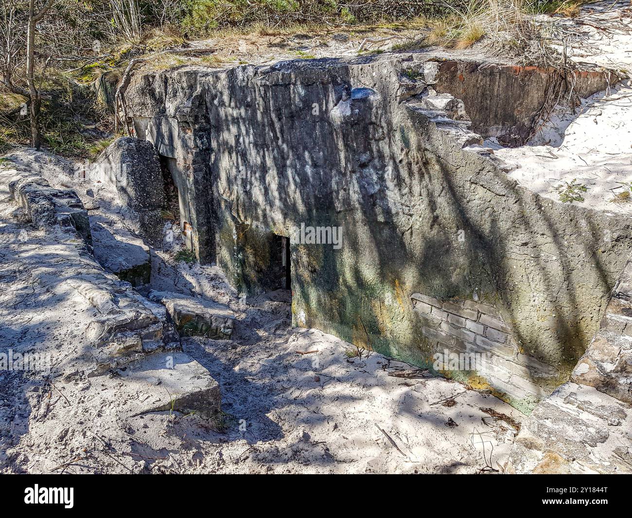 Abandoned former WWII bunker on sandy hill, ruined structure and walls ...