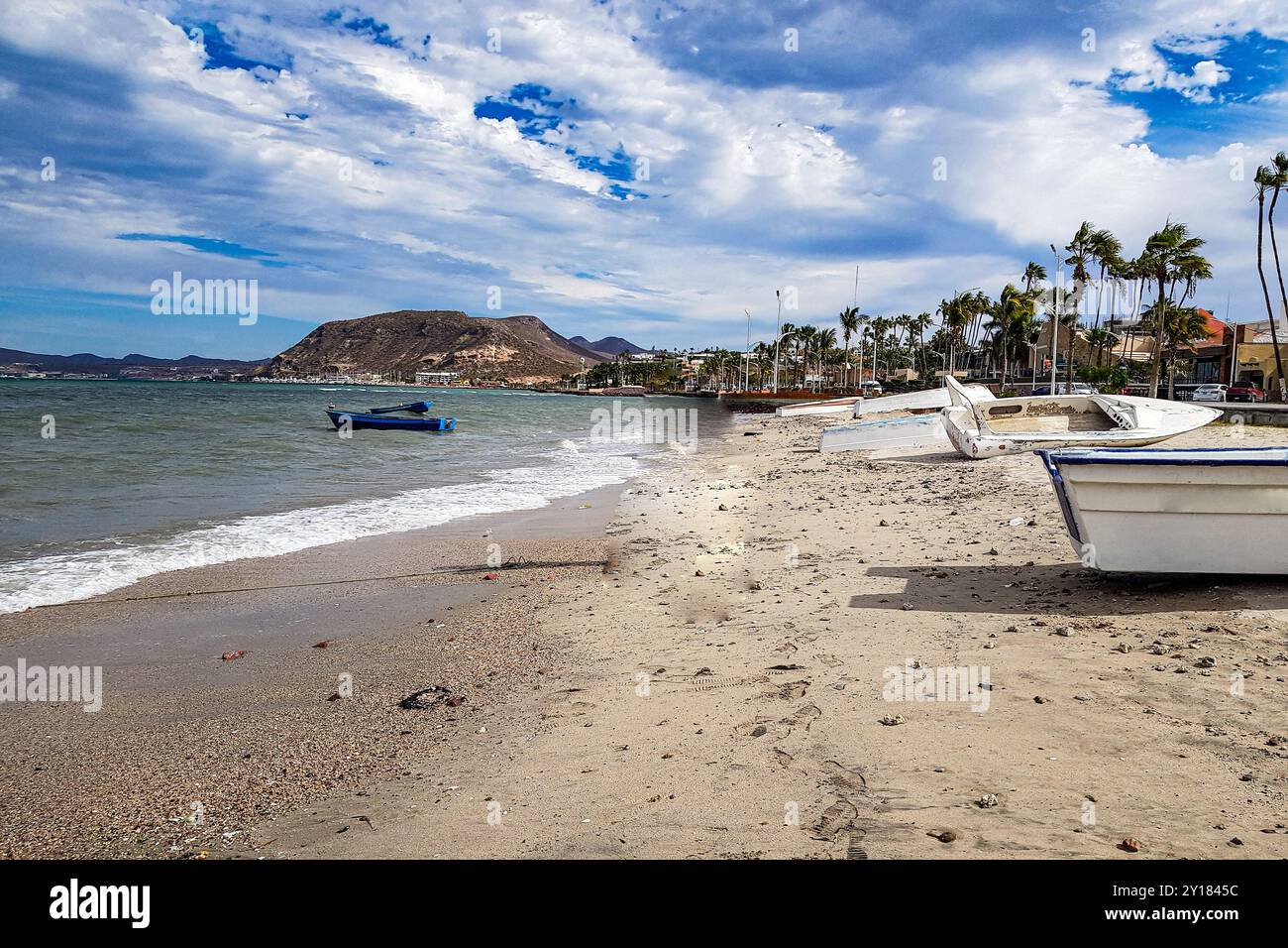 Coastal beach landscape, boats on sand and waters of Sea of Cortez ...