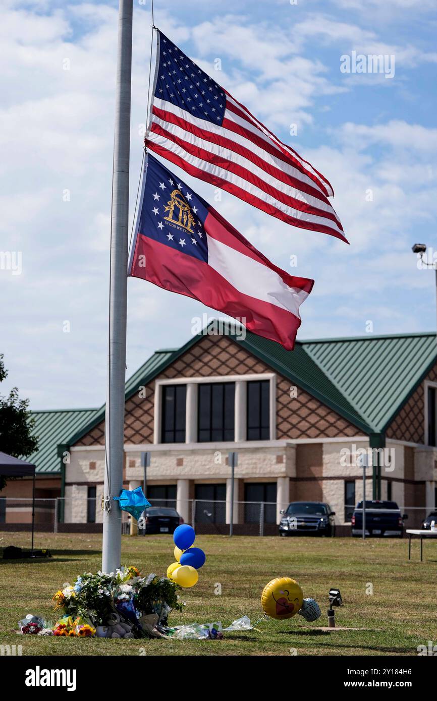 The American and state of Georgia flags fly half-staff after a shooting ...