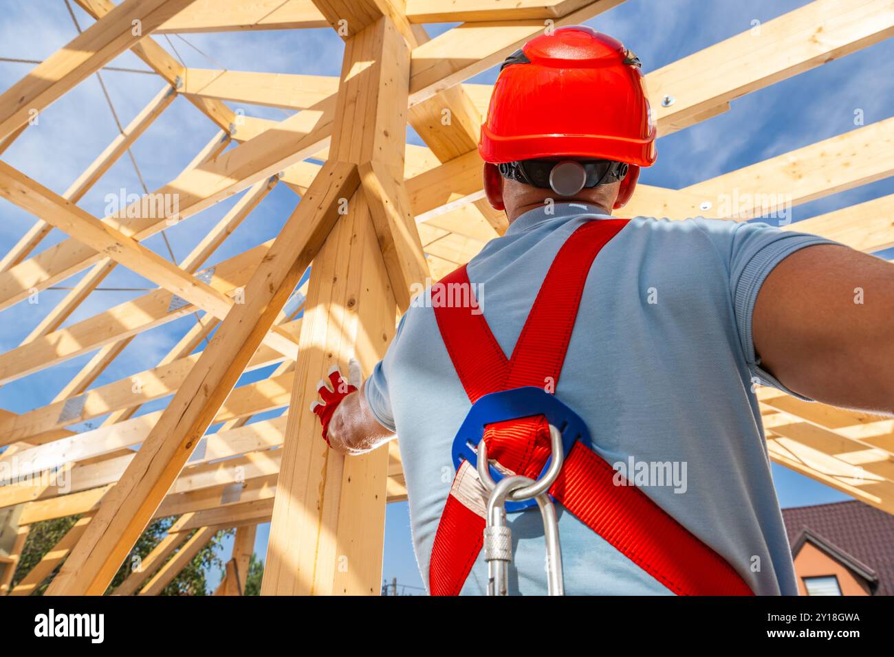 A construction worker in a safety helmet directs the installation of ...