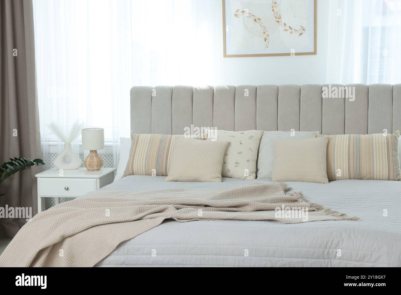 Big comfortable bed in room. Interior design Stock Photo - Alamy