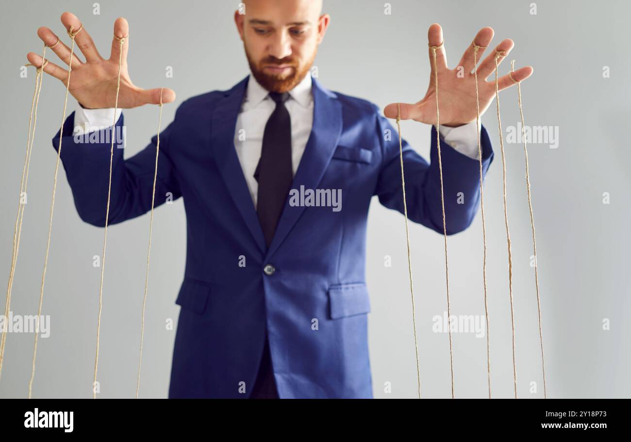 Man moving hands and controlling puppet strings illustrating concept of ...