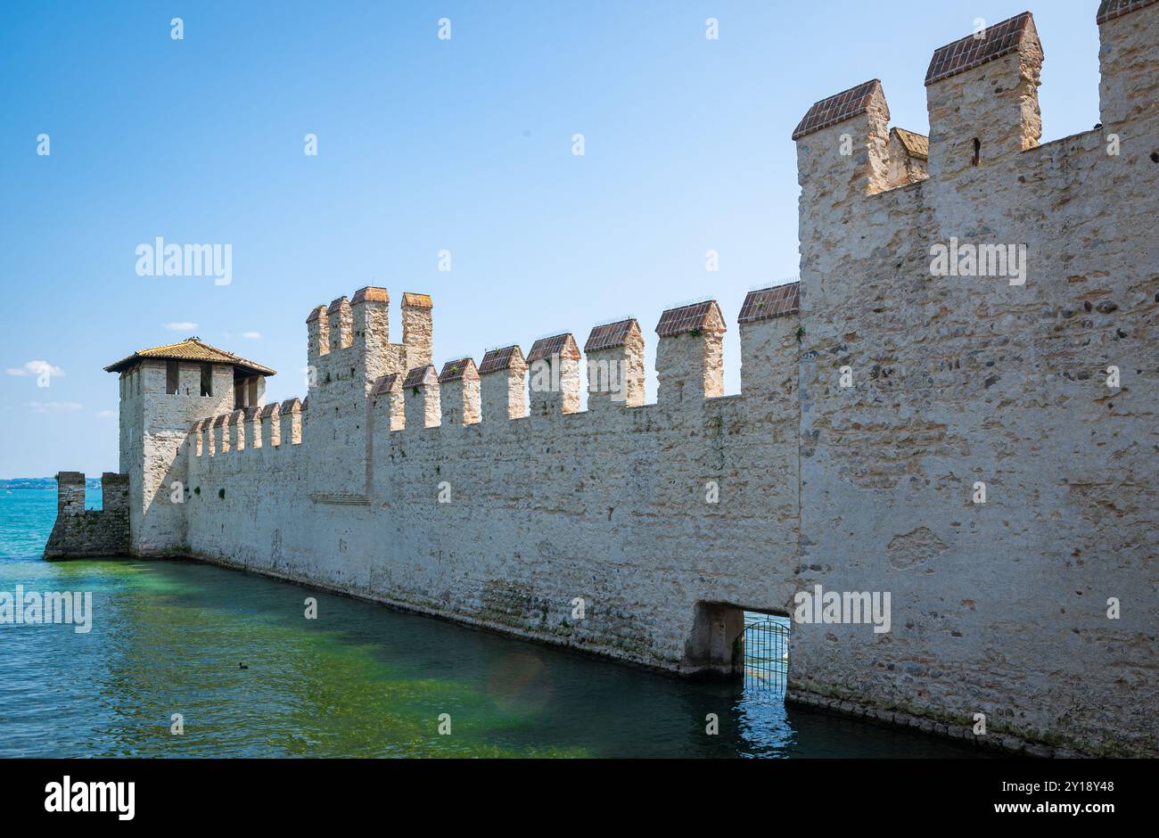 Wall with battlements of the medieval castle Rocca Scaligera in the ...