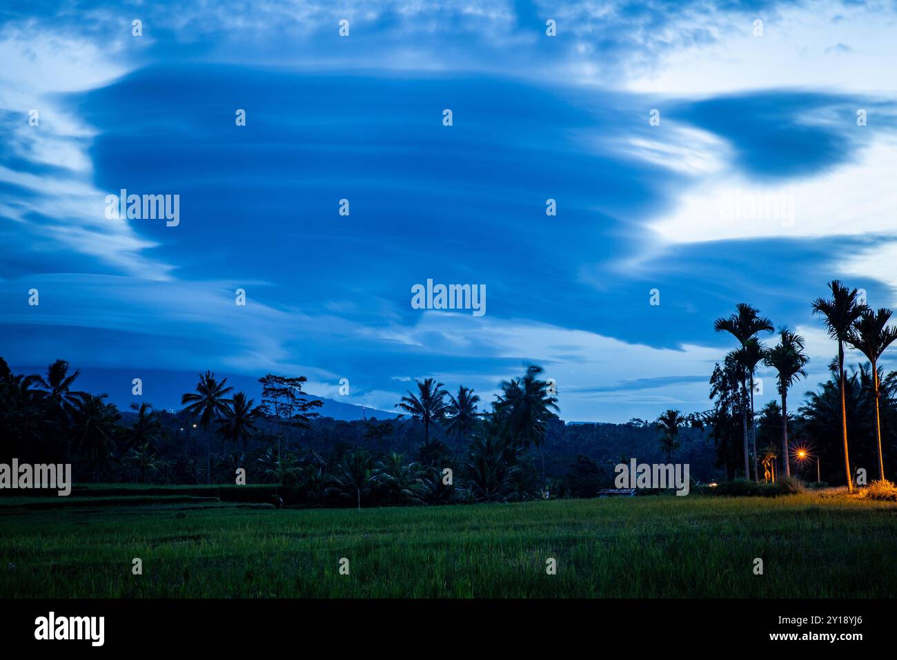 Lenticular Cloud shown from a rice patty Stock Photo - Alamy