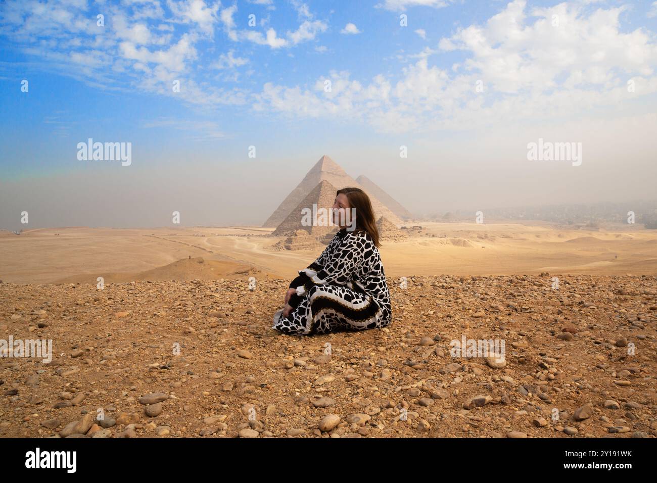 Back view of a woman in a long traditional Muslim dress looking at the ...