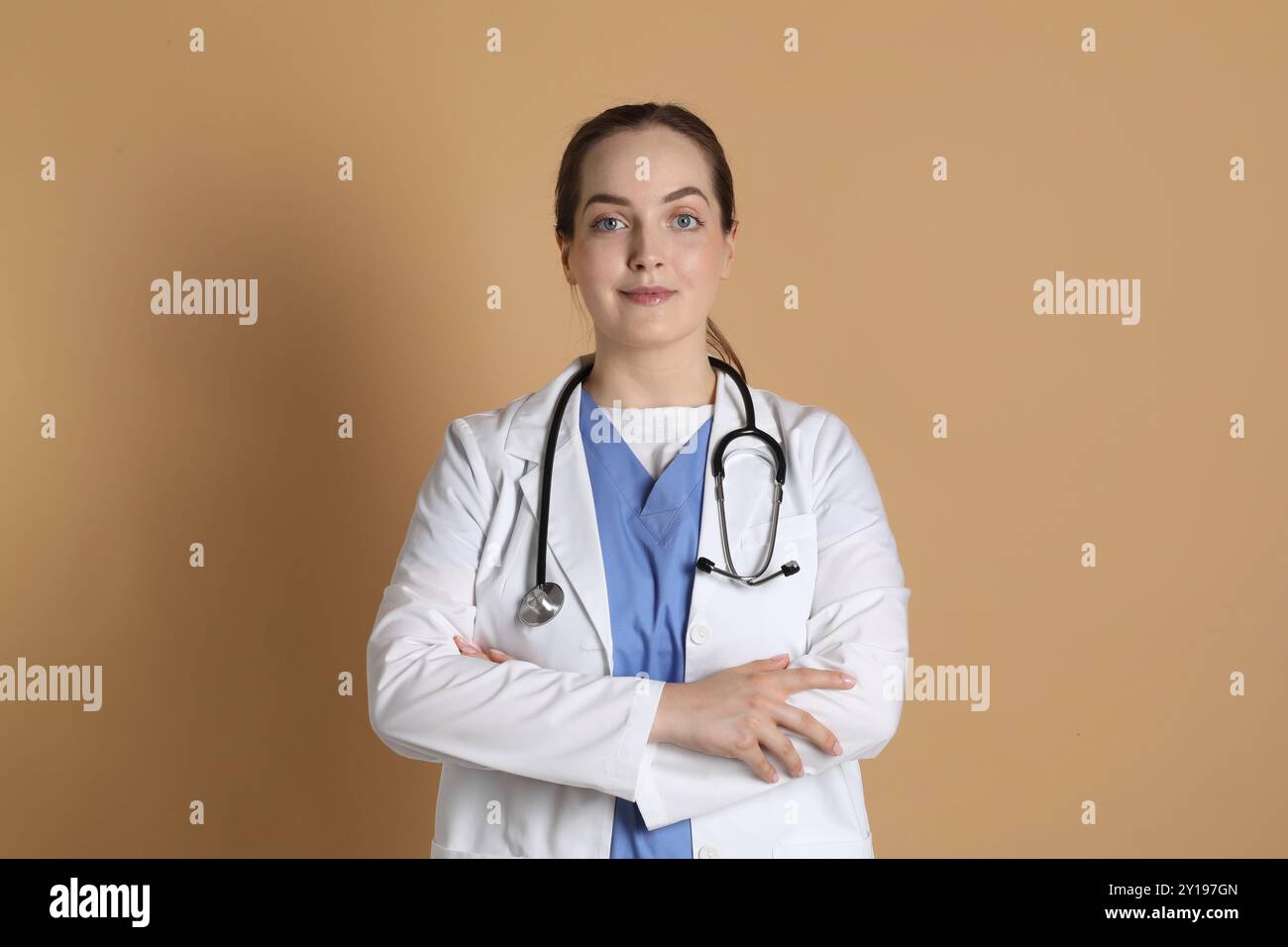 Portrait of professional nurse on dark beige background Stock Photo - Alamy
