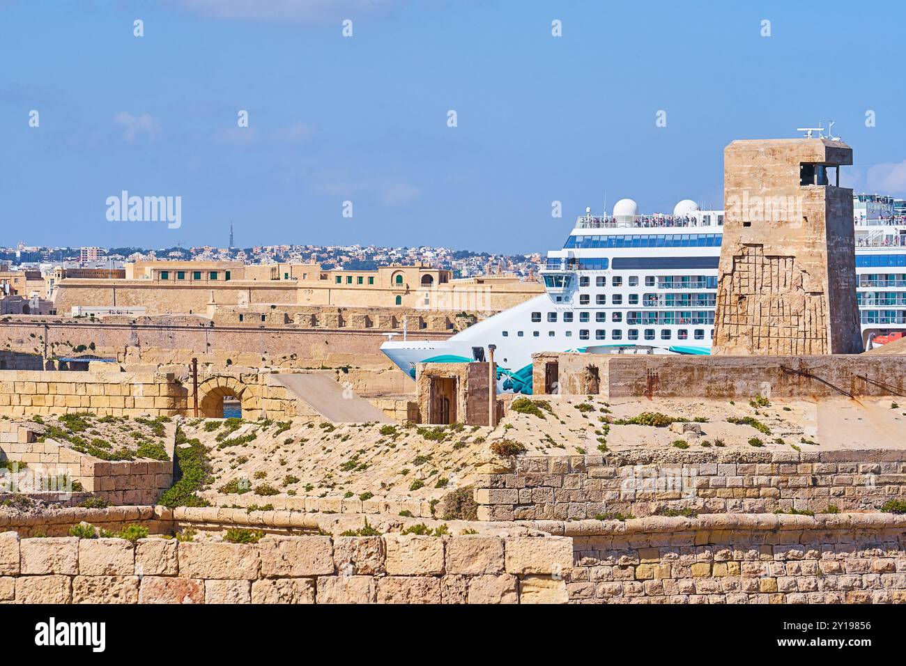 Modern cruise ship enters Grand Harbour Valletta near ancient stone ...